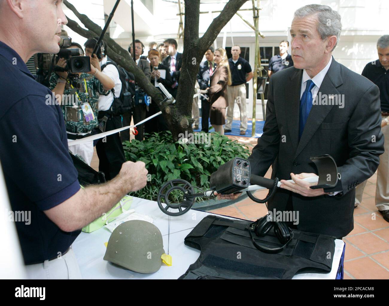 U S President George W Bush Right Receives An Explosive Ordinance