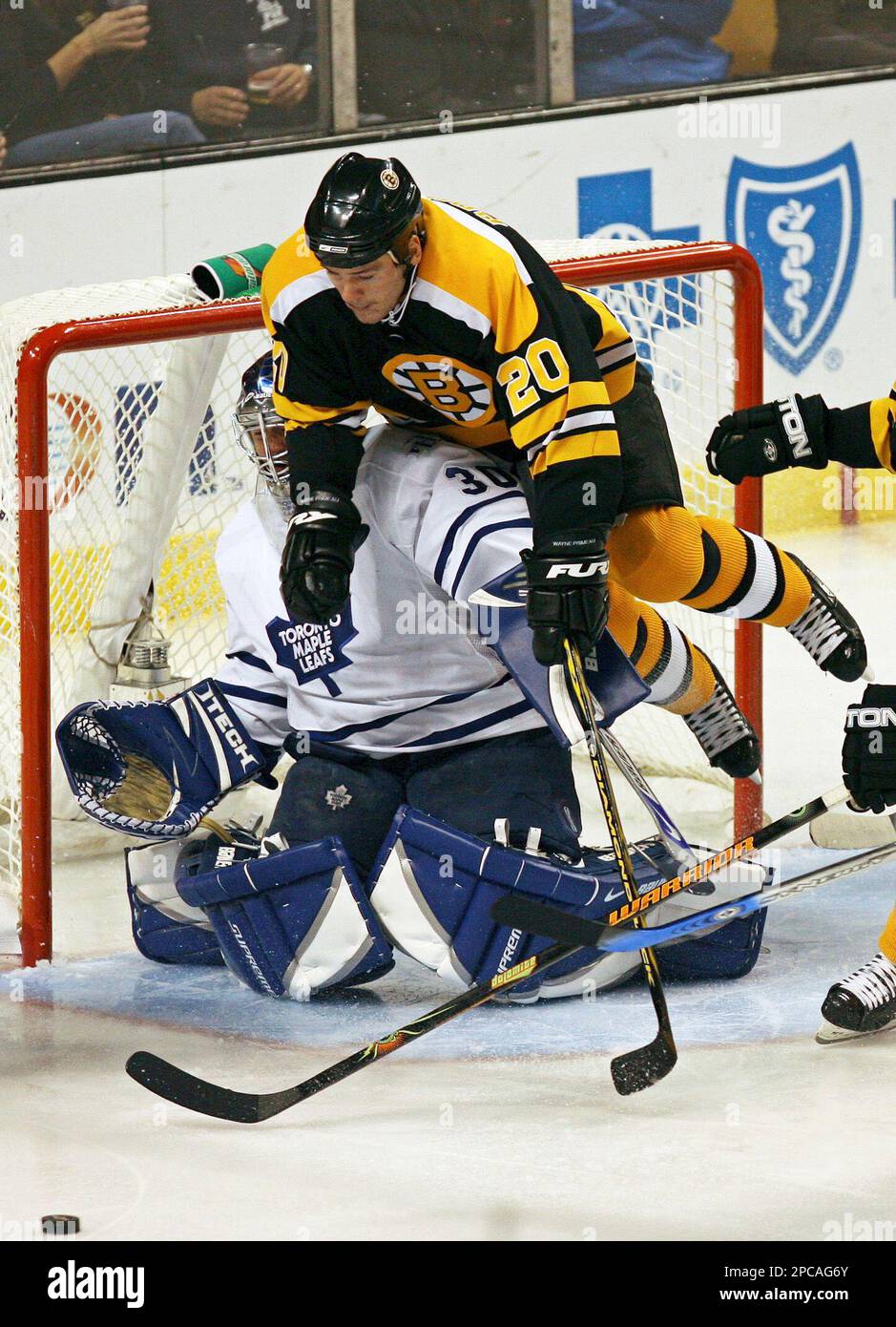 Boston Bruins' Wayne Primeau (20) goes over Toronto Maple Leafs goalie ...