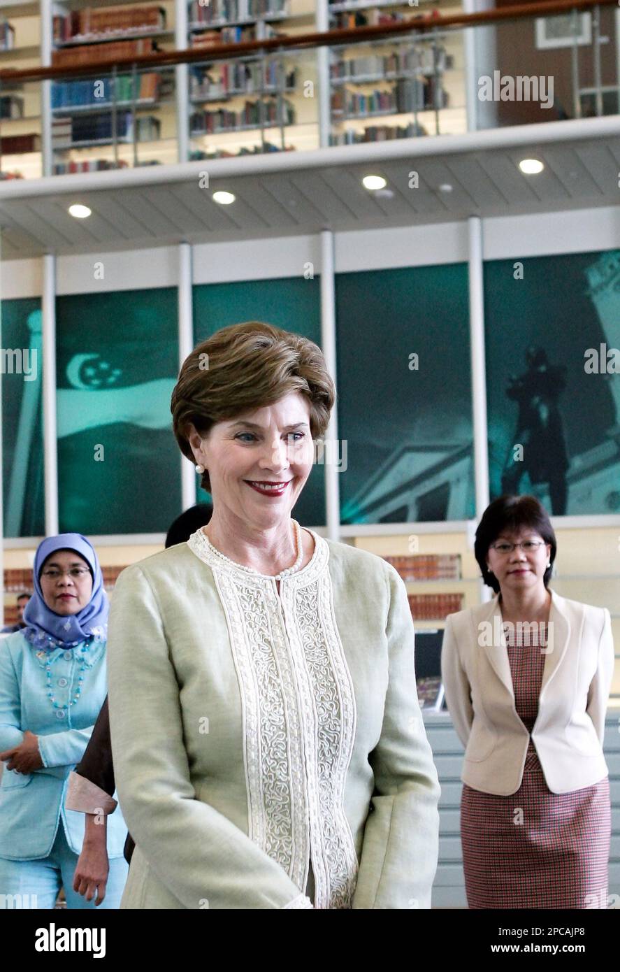 U.S. first lady Laura Bush, center, is escorted by library staff ...