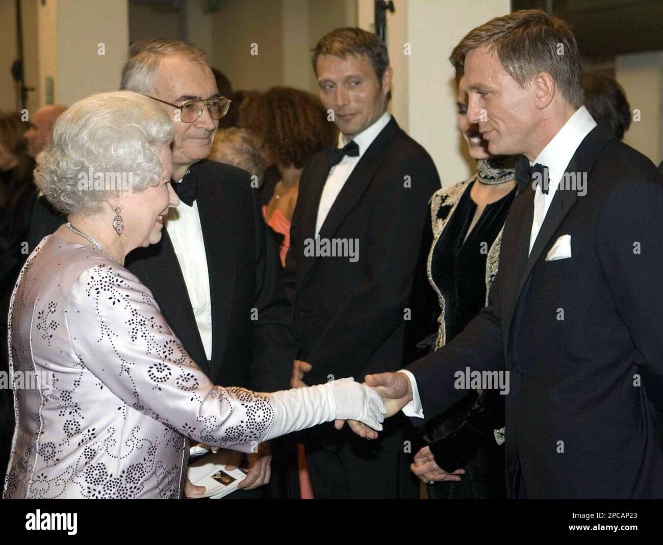 Britain's Queen Elizabeth II, left, meets actor Daniel Craig, the new ...