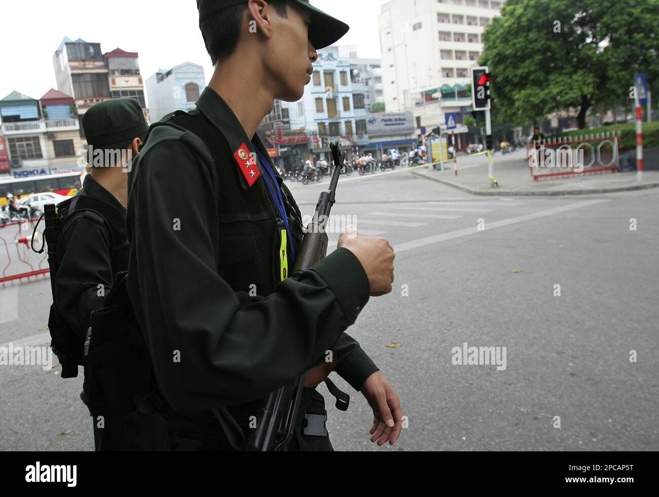 Vietnamese security police officers patrol outside a hotel where APEC ...