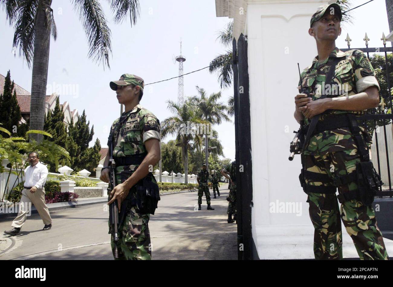 Indonesian soldiers stand guard in preparation for an upcoming visit by ...