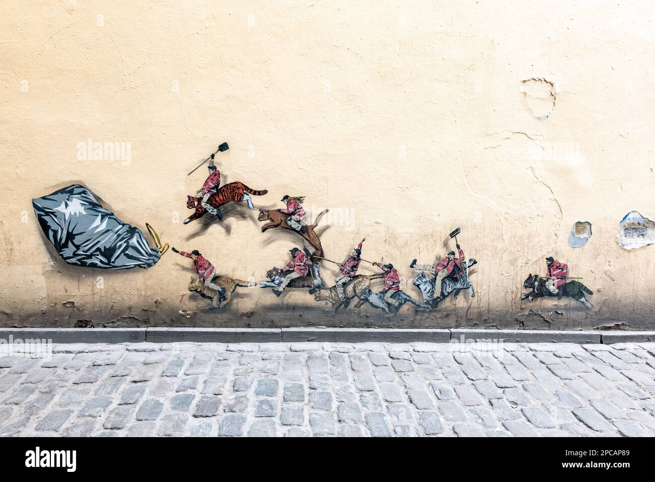 Banksy style graphics on wall in Brussels of men in red coats on cats ...
