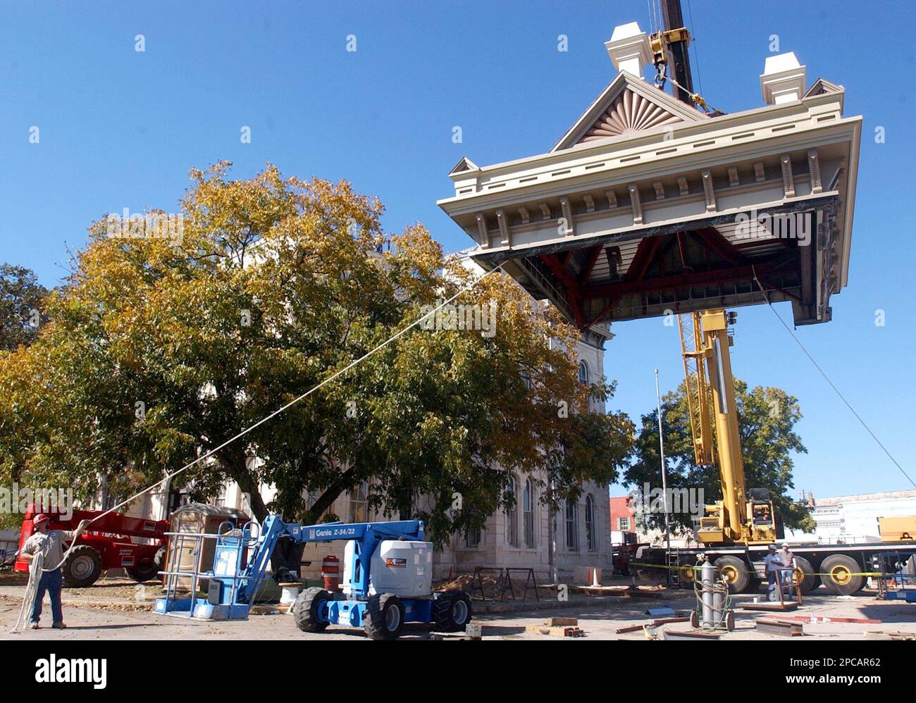 Work crews guide one of four turrets onto the Bosque County Courthouse ...