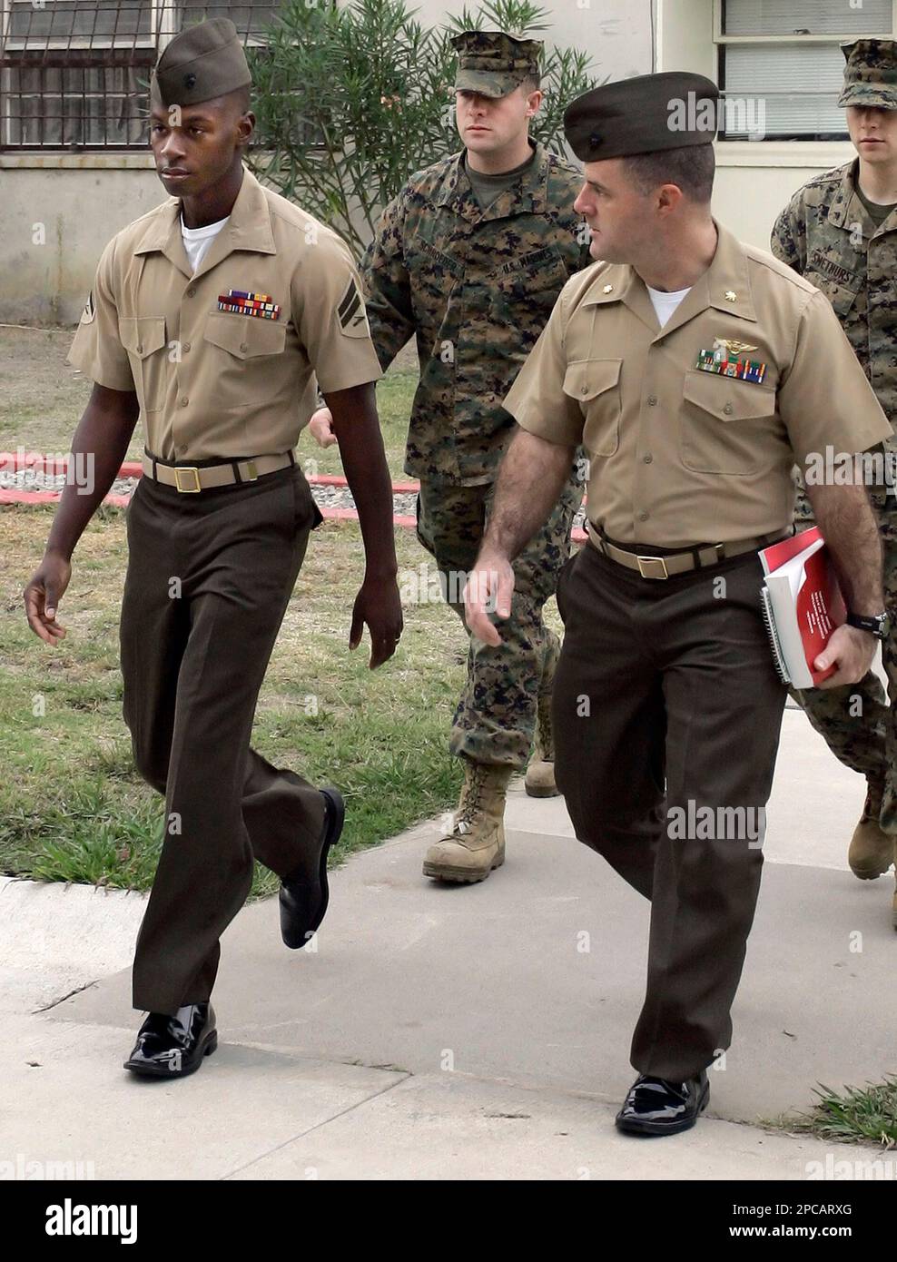 U.S. Marine Corps Cpl. Trent D. Thomas, left, is led to his arraignment ...