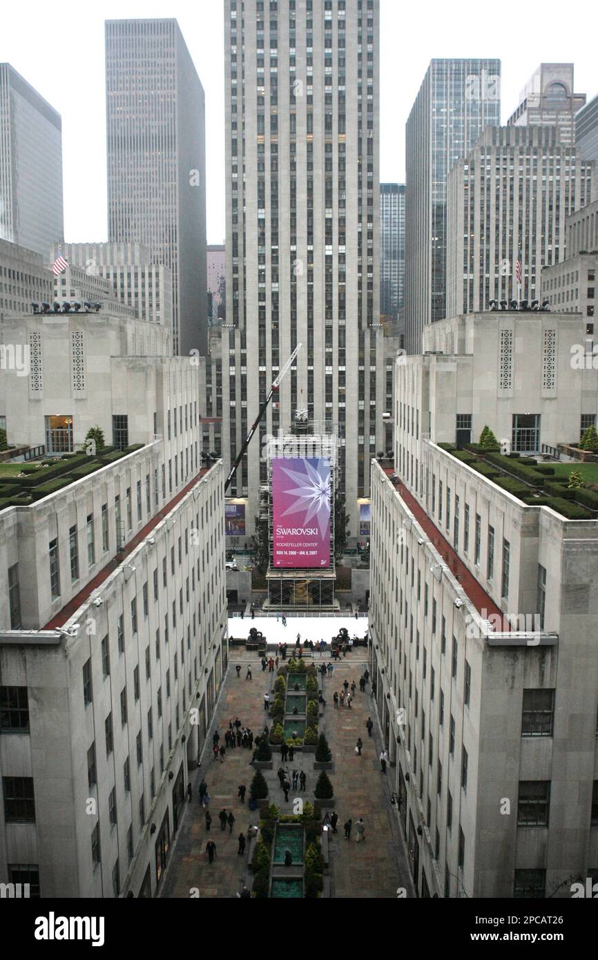 A Swarovski crystal star is lifted into its final position atop the ...
