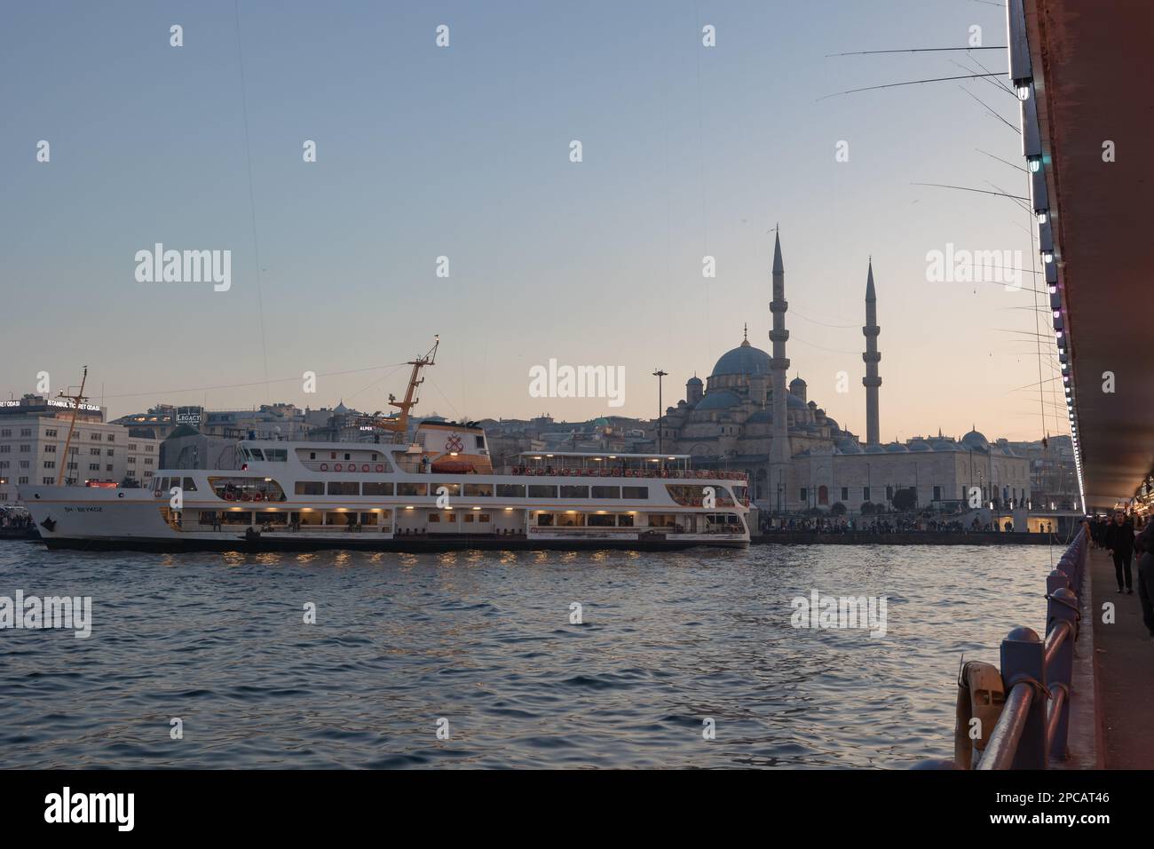 Istanbul ferries. Ferry and Eminonu Yeni Cami or New Mosque at sunset ...
