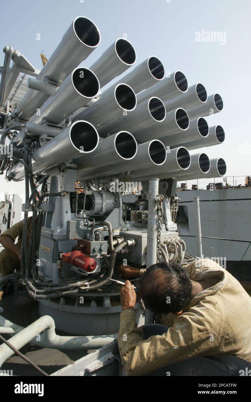 A mechanic works on a WM 18A Rocket launcher mounted on board INS ...