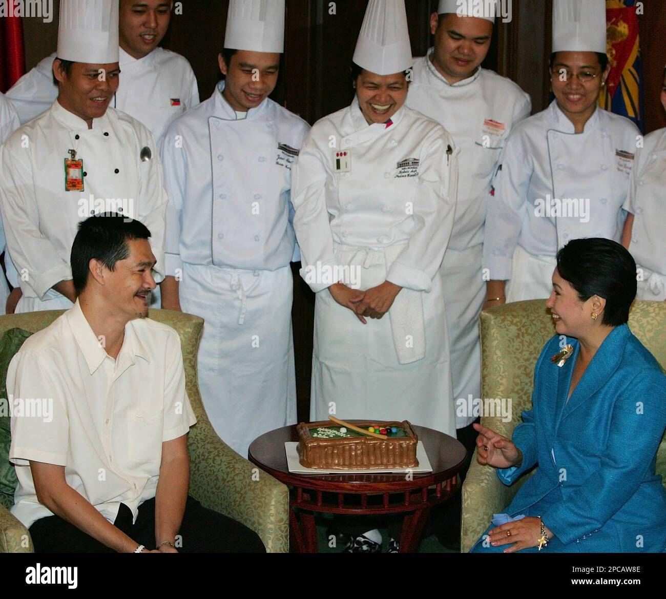 President Gloria Macapagal Arroyo right, gestures towards Ronato Alcano ...