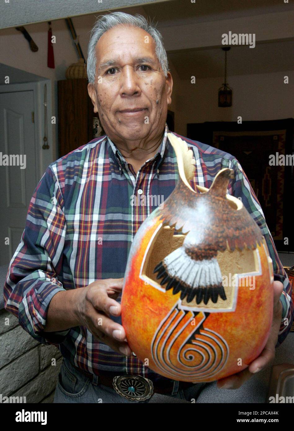 Native American artist Emil Pedro displays one of his carved gourd ...