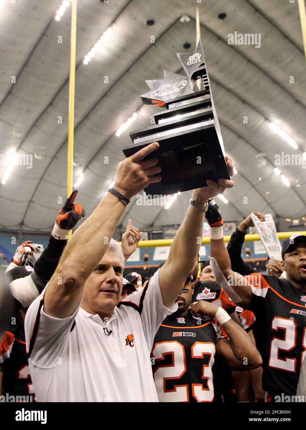 B.C. Lions head coach Wally Buono holds up the CFL Western Division ...