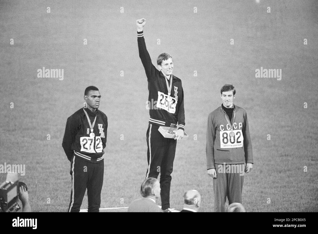 FILE - Gold medal winner Dick Fosbury raises his arm on the victor's ...