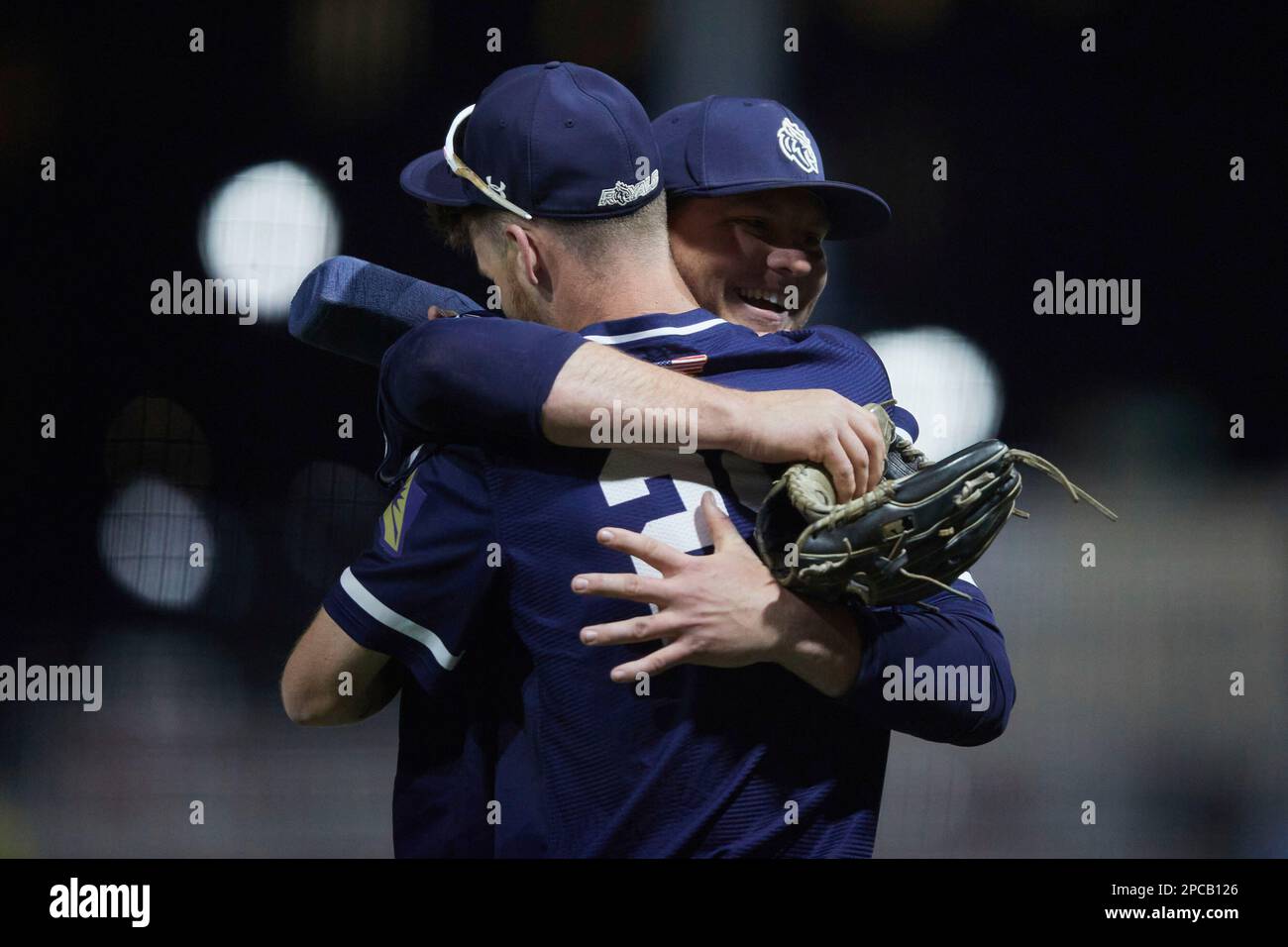 Queens Royals starting pitcher Daniel Bagwell (50) gets a hug from ...