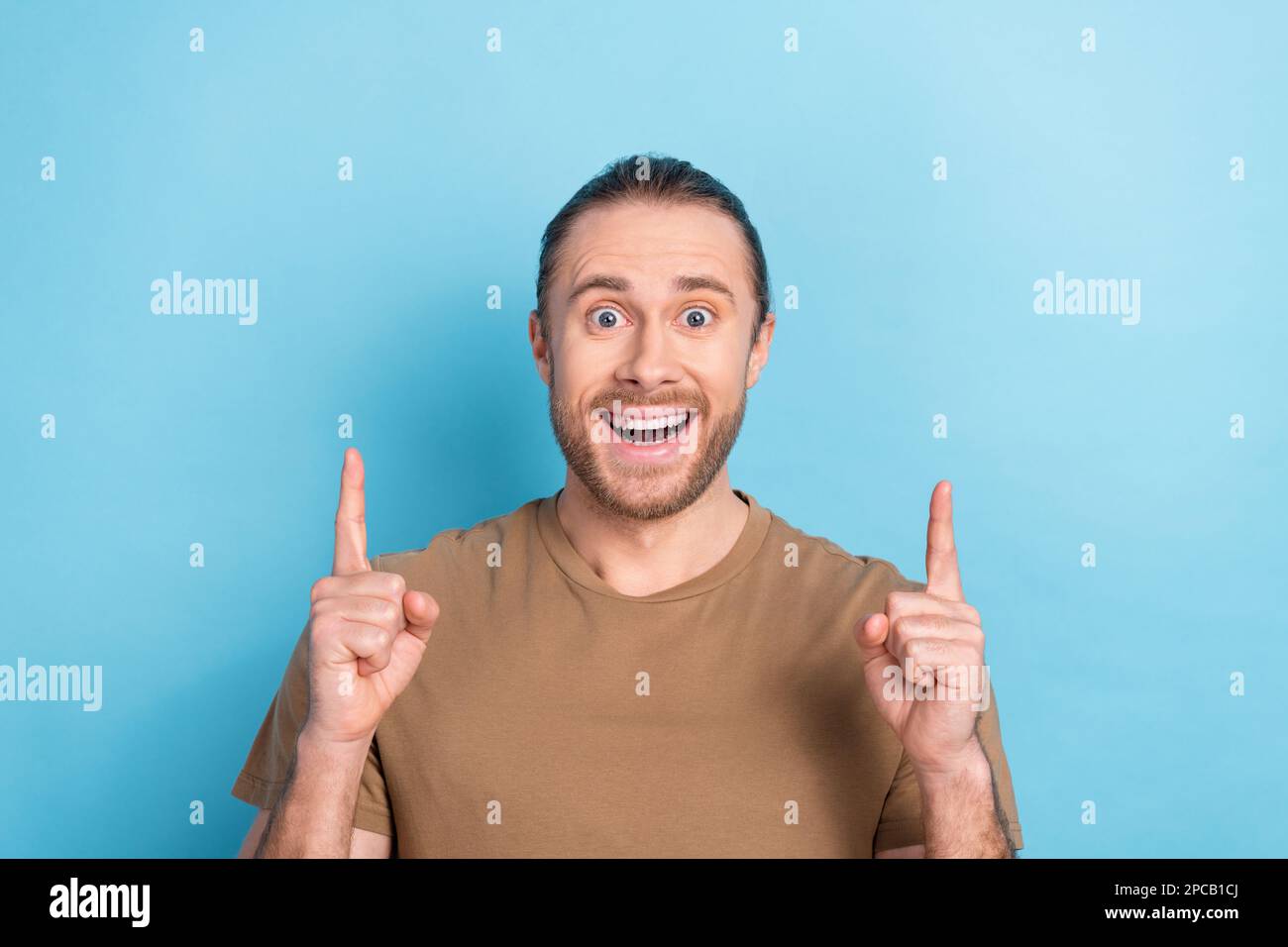 Photo of astonished cheerful person beaming smile indicate fingers up ...