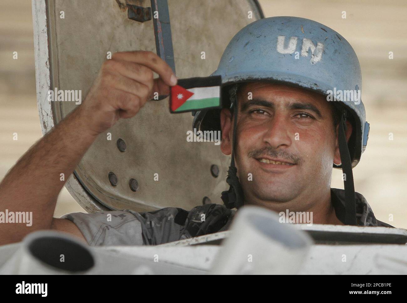 A U.N. Jordanian peacekeeper shows a stamp of Jordan's flag as he is on ...