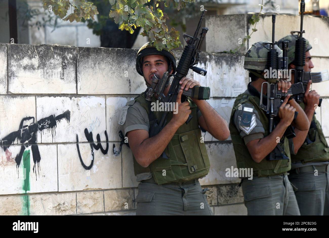 Israeli soldiers take up positions during an army operation in the West ...