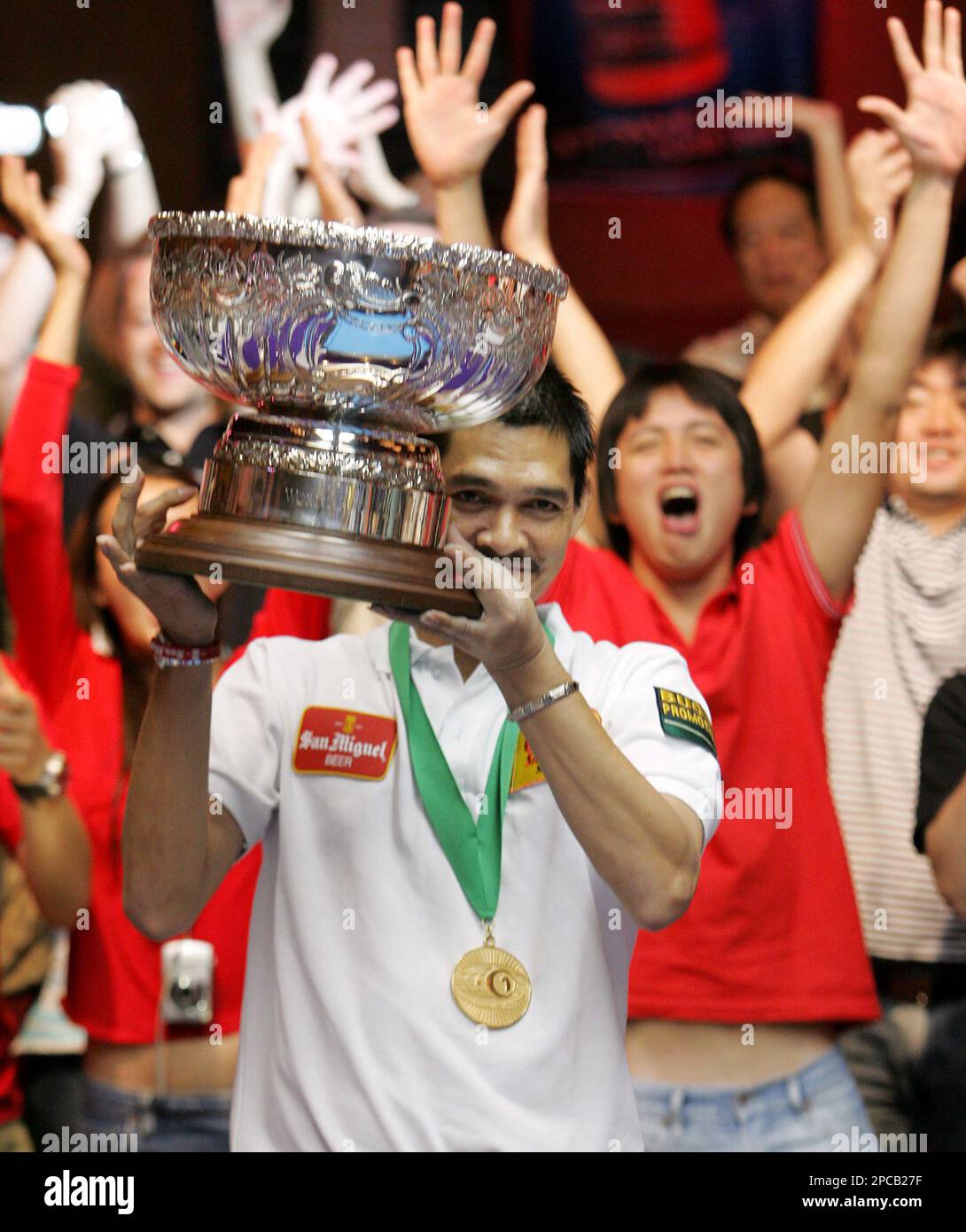 The crowd cheers as Philippines' Ronato Alcano carries his trophy after ...