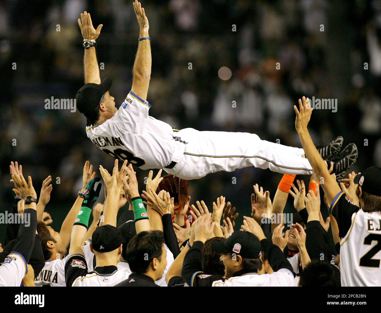 Japan's Nippon Ham Fighters players toss their manager Trey Hillman ...