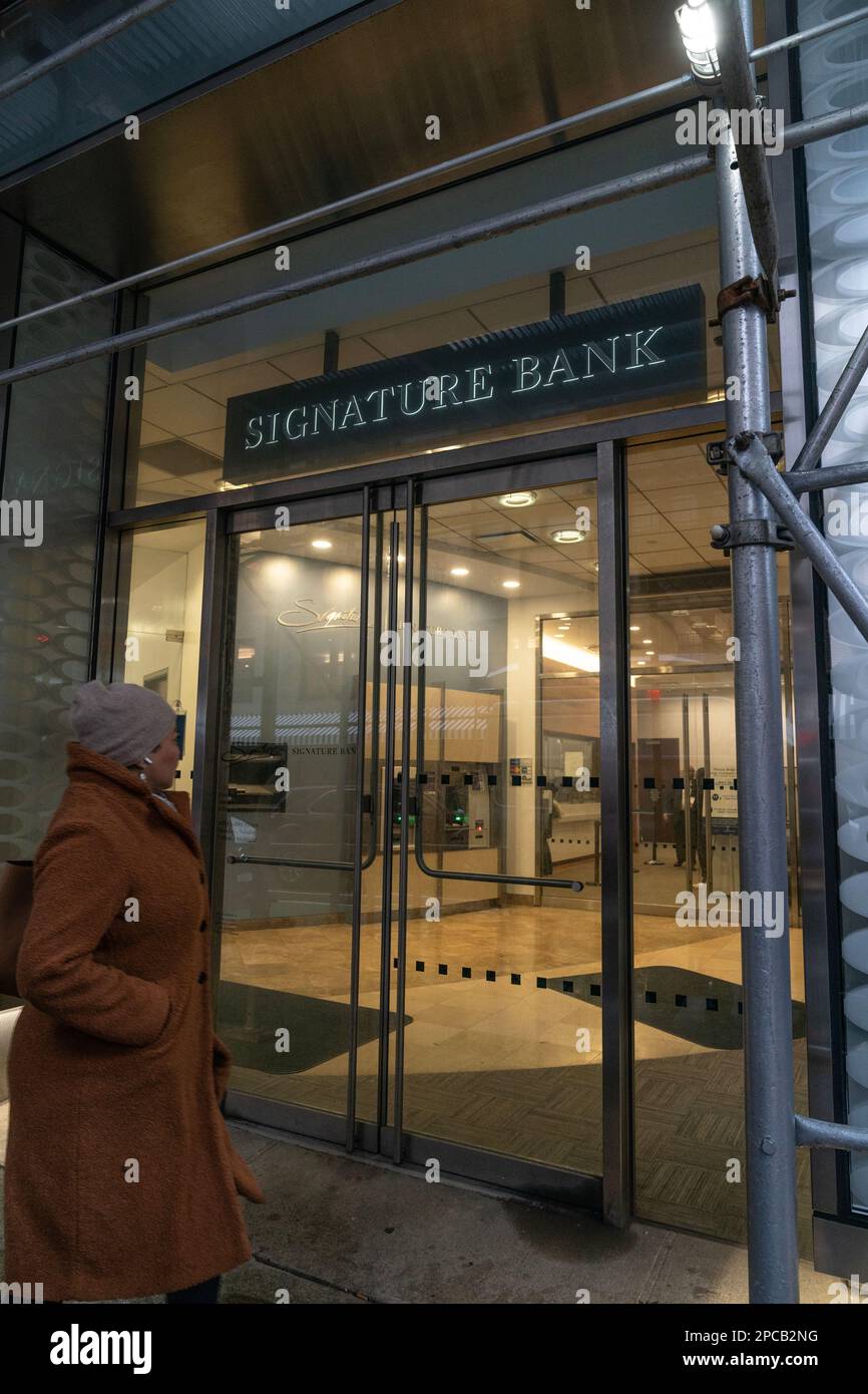 A person walks by Signature Bank branch in New York on March 13, 2023 ...