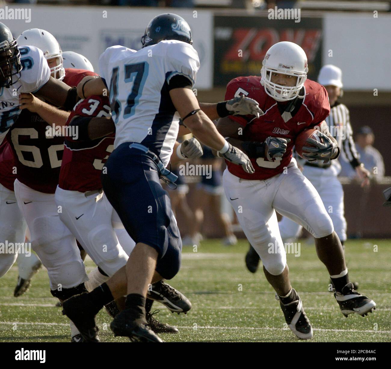 Massachusetts' Steve Baylark (5) follows the blocking by teammate John ...