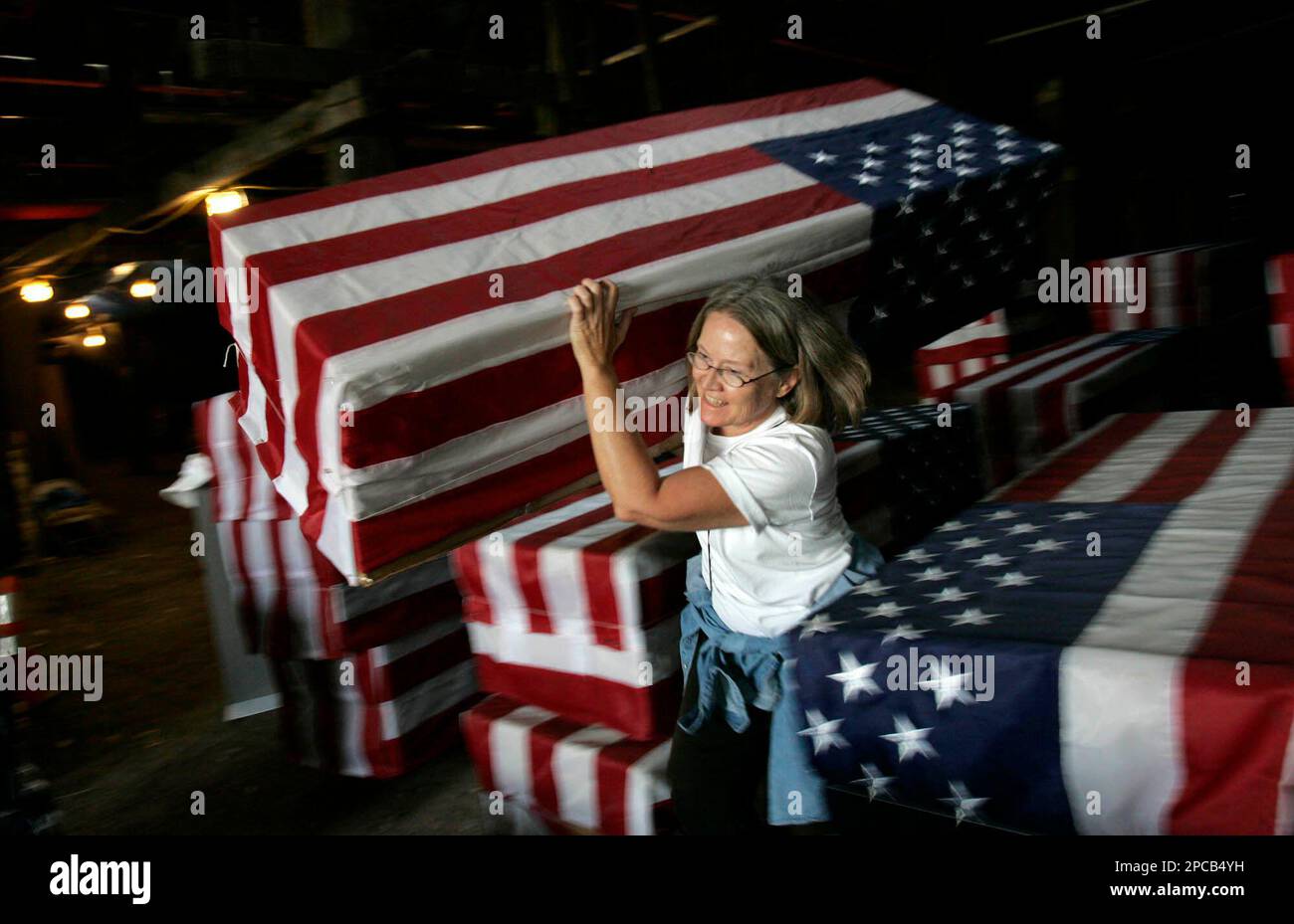 Volunteer Kitty Joyner carries mock flag-draped coffin that is being ...