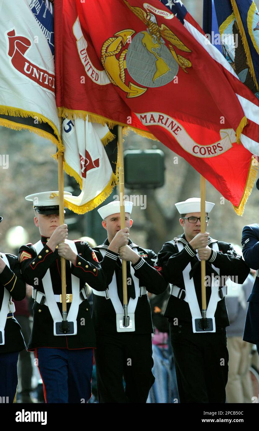 A color guard carries flags through the streets of downtown Denver to ...