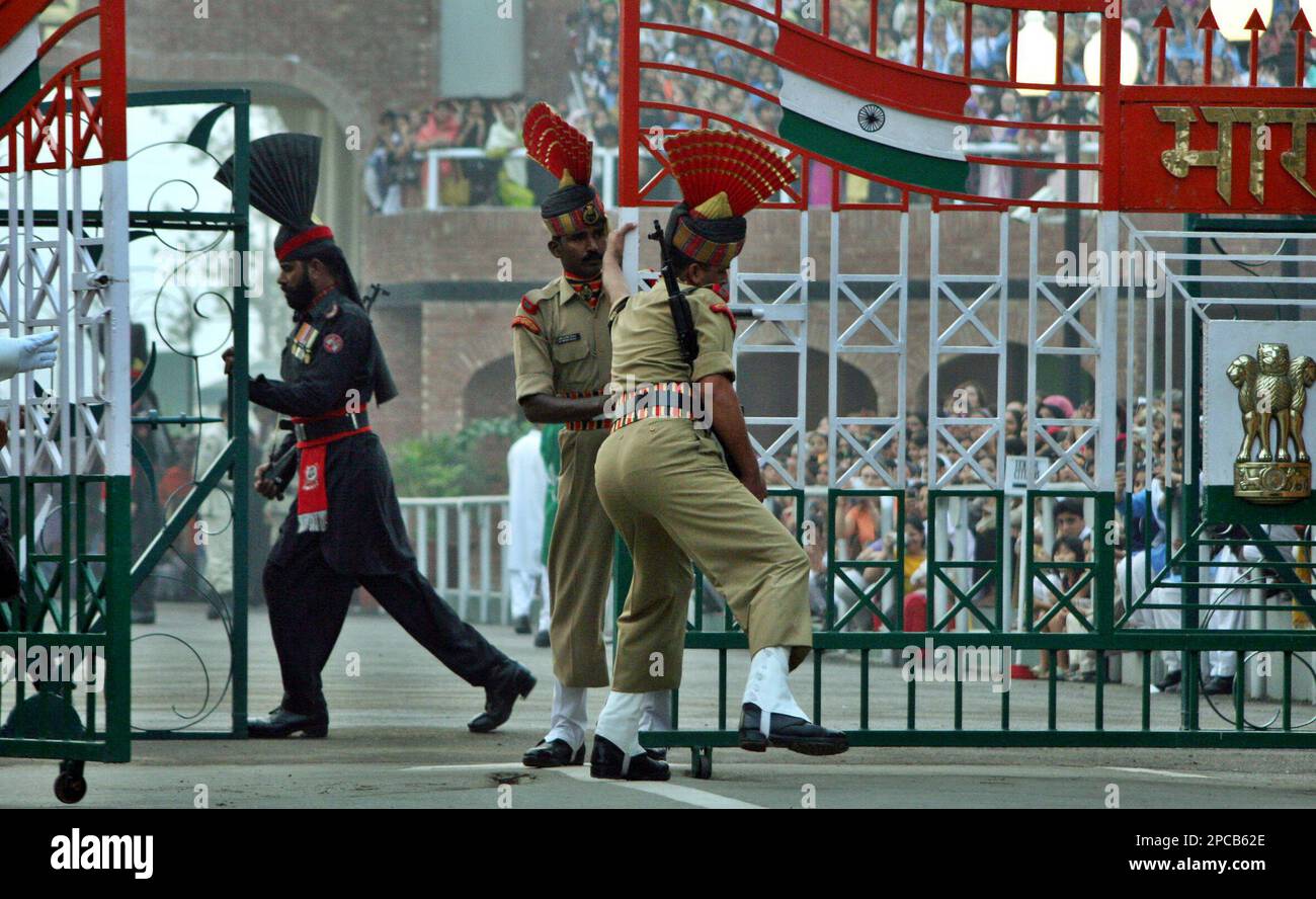 Indian Border Security Force soldiers, right, and a Pakistani Ranger ...