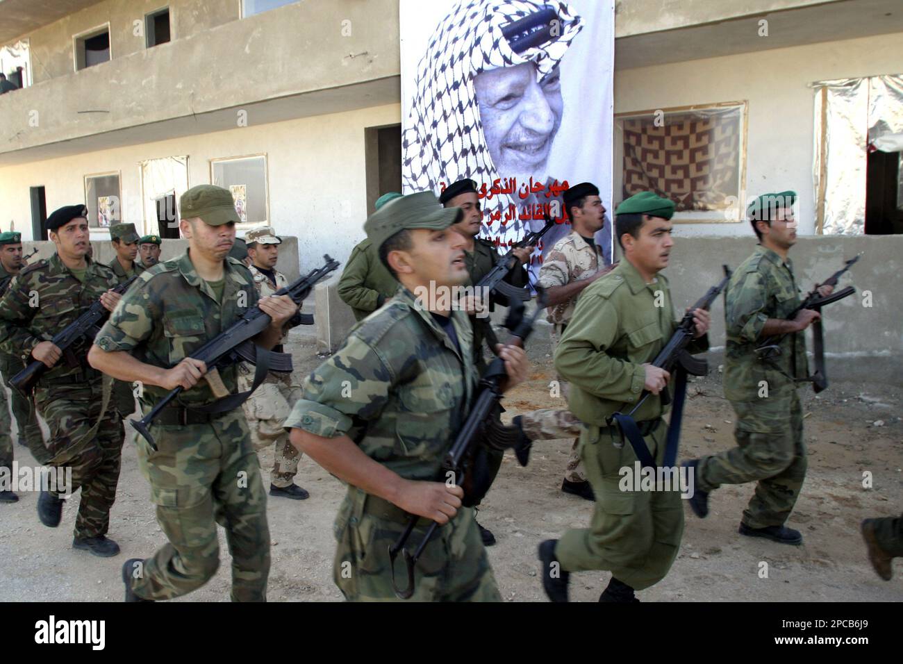 Palestinian officers march during a ceremony to commemorate the second ...