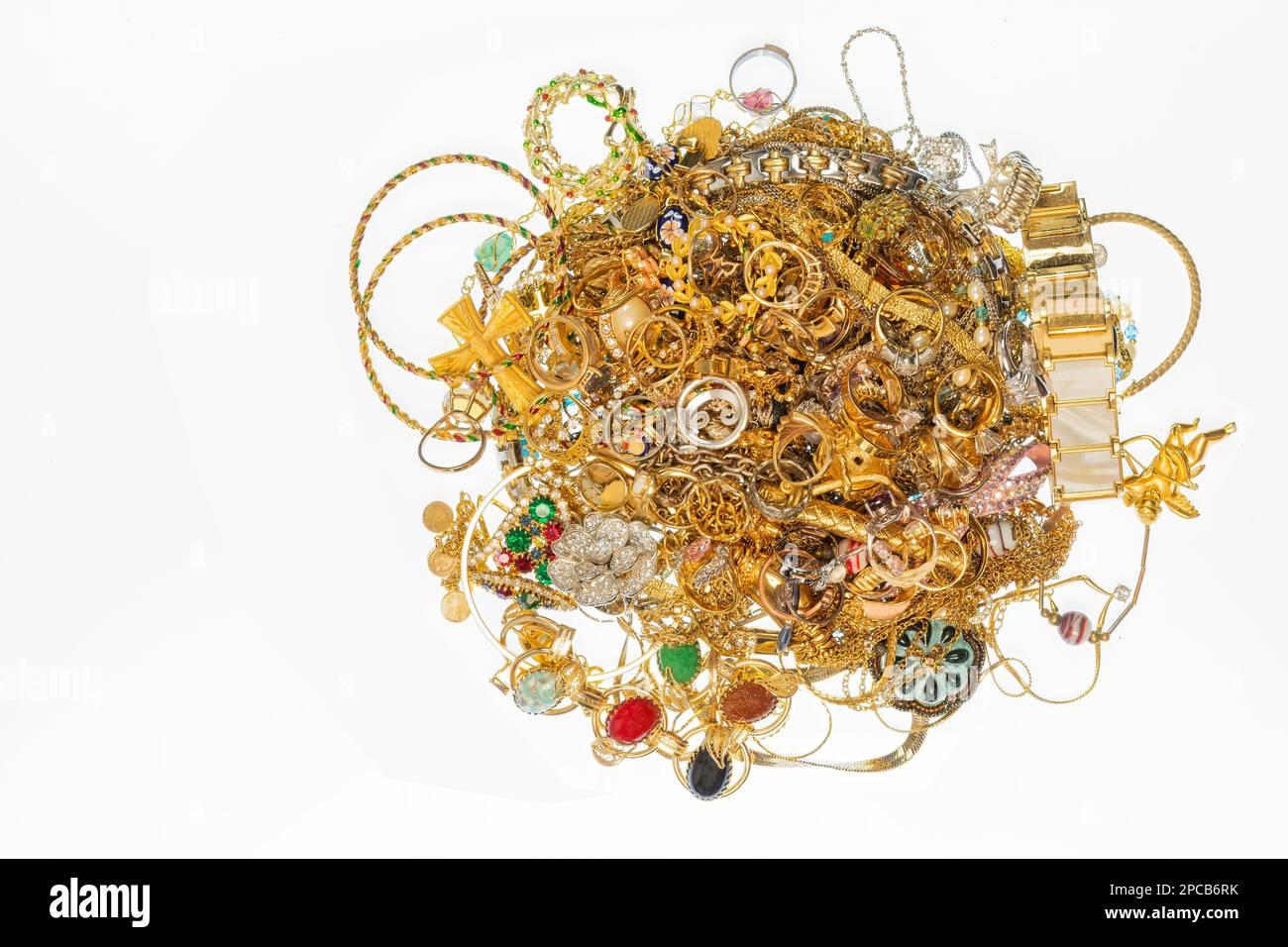 Horizontal shot of a pile of gold jewelry with copy space on a white ...