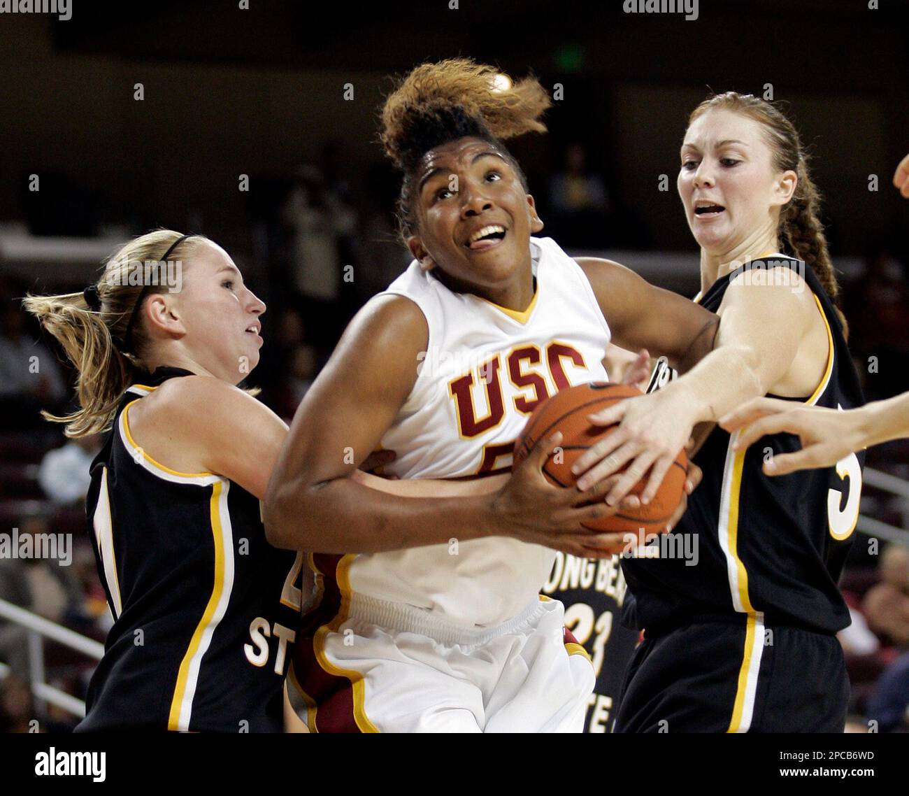 Southern California's Morghan Medlock, center, tries to drive to the ...