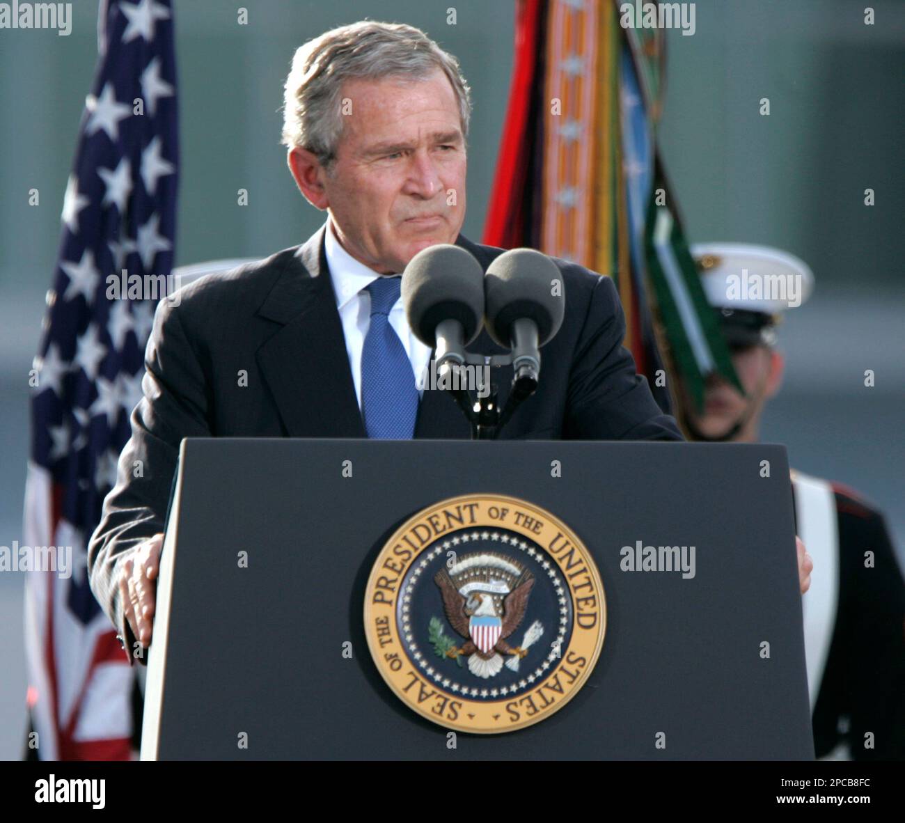 President Bush becomes emotional while looking toward the family of a ...