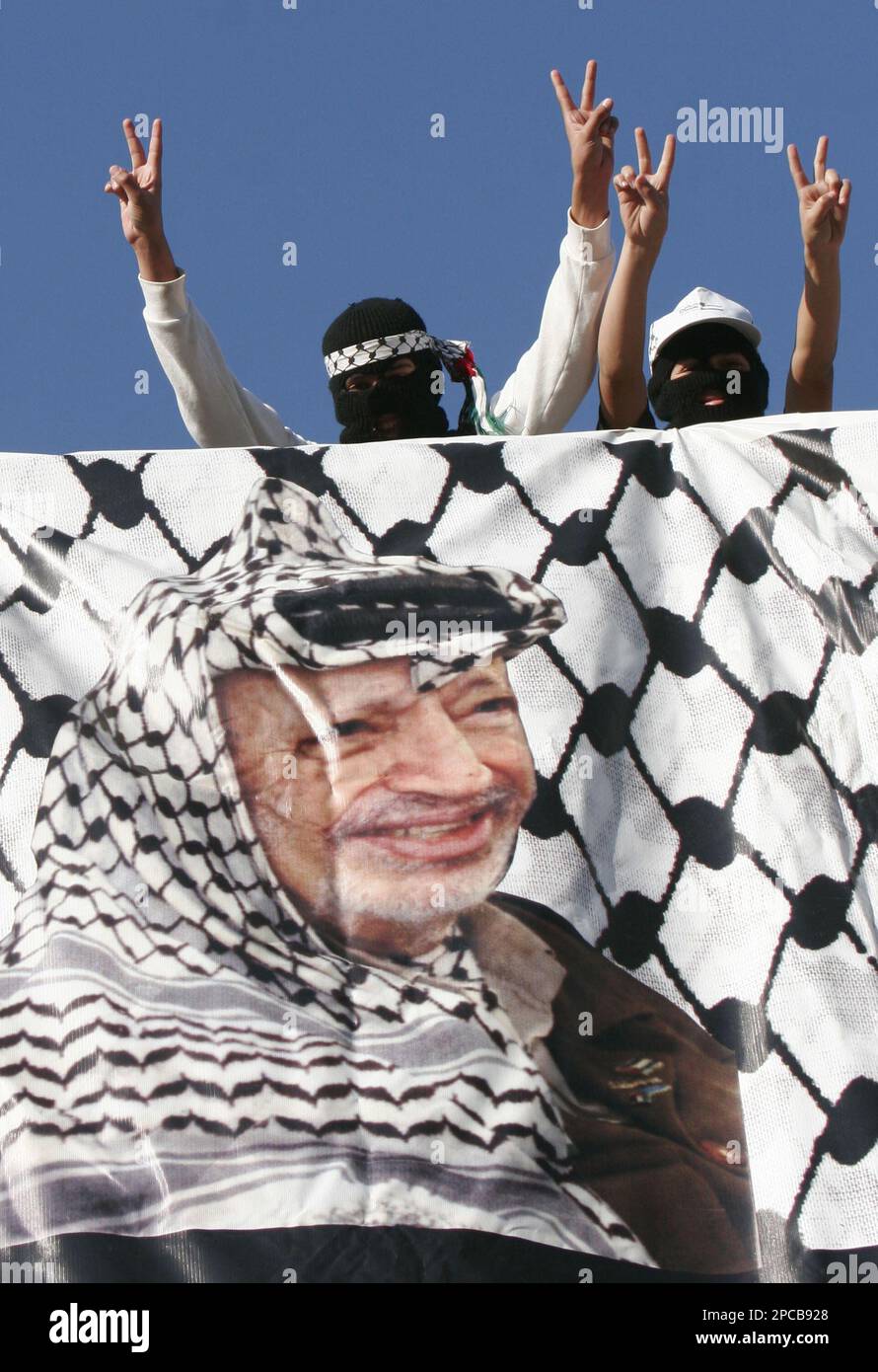 Masked supporters of the Fatah movement, which was headed by the late ...