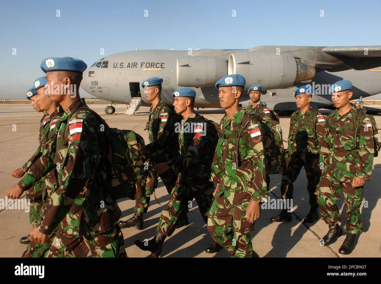 Indonesian U.N. peacekeepers walk past a U.S. Air Force plane upon ...