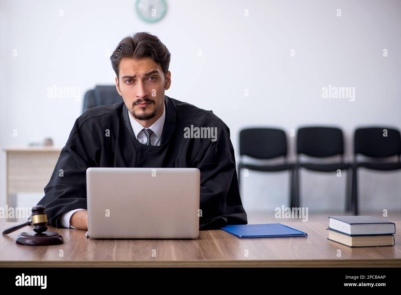Young judge working in the courthouse Stock Photo - Alamy