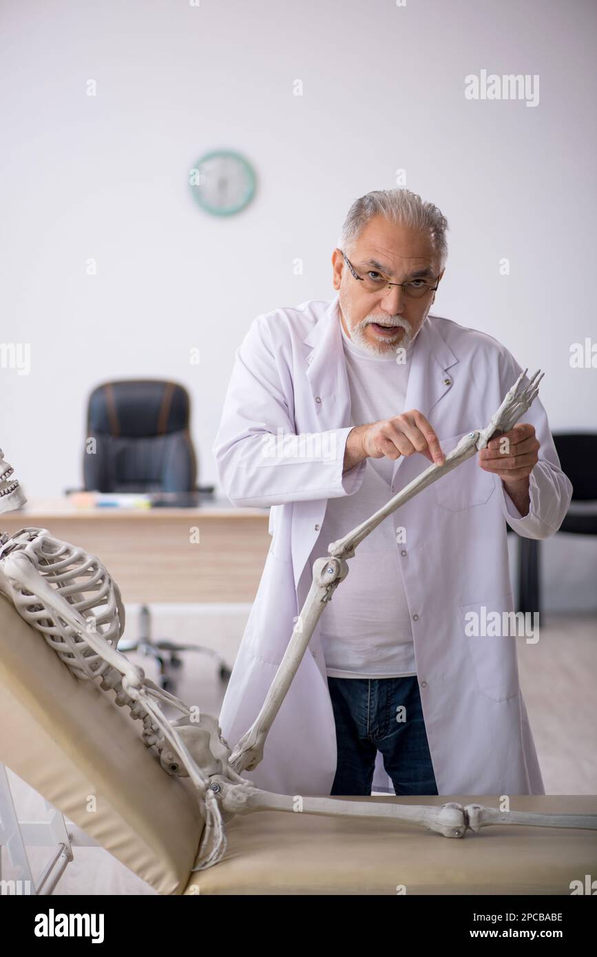 Old doctor with skeleton at the hospital Stock Photo - Alamy
