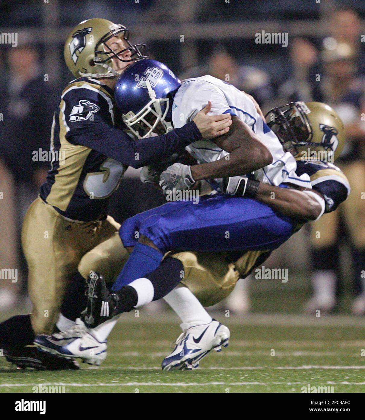 Akron's Matt Domonkos, left and Amin Kabir, right, take down Buffalo's ...