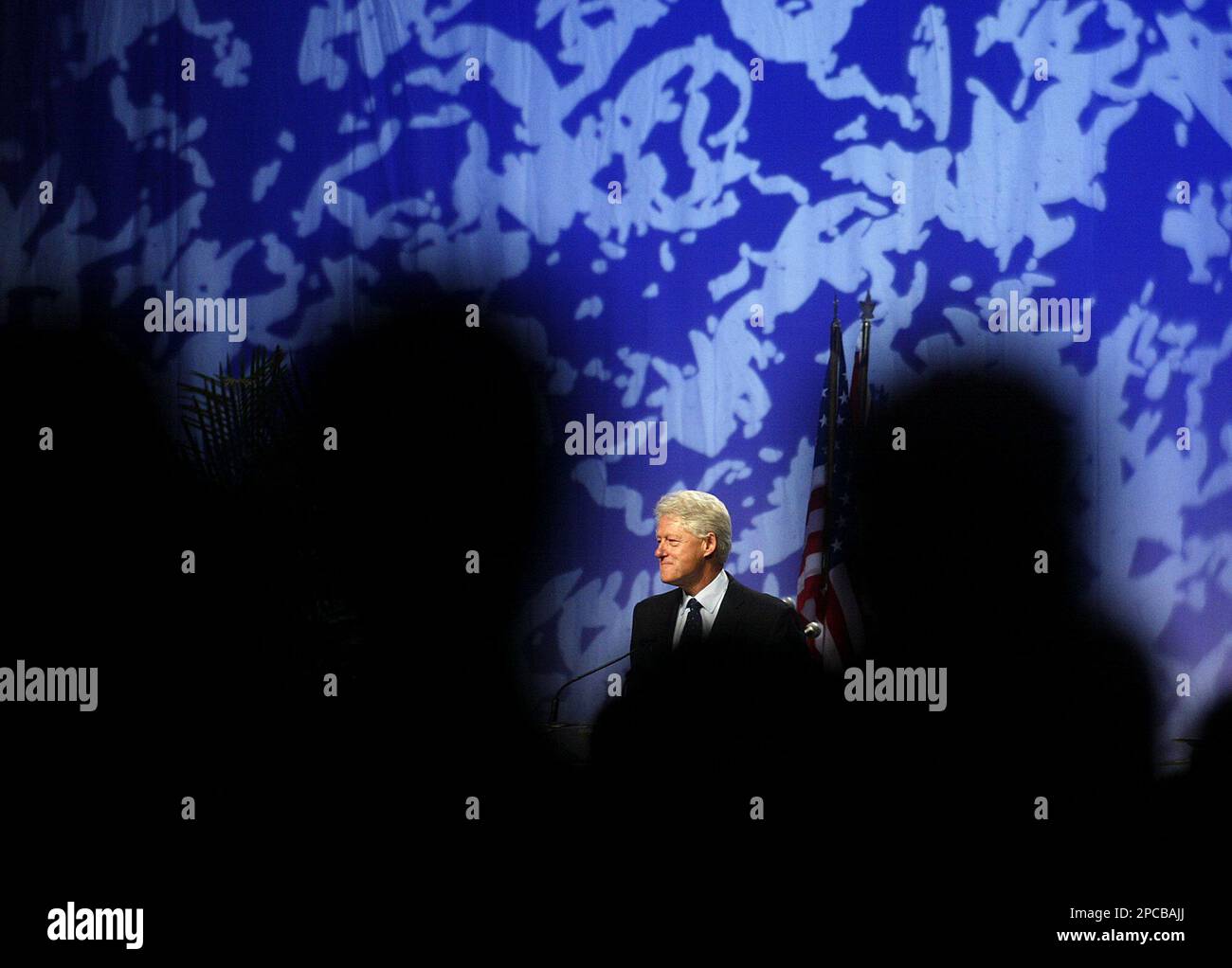 Former President Bill Clinton gets a standing ovation before speaking ...