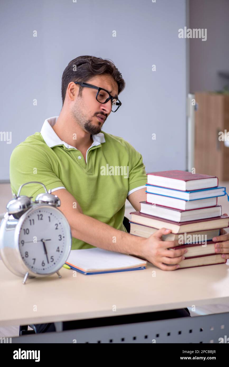 Young student in time management concept Stock Photo - Alamy