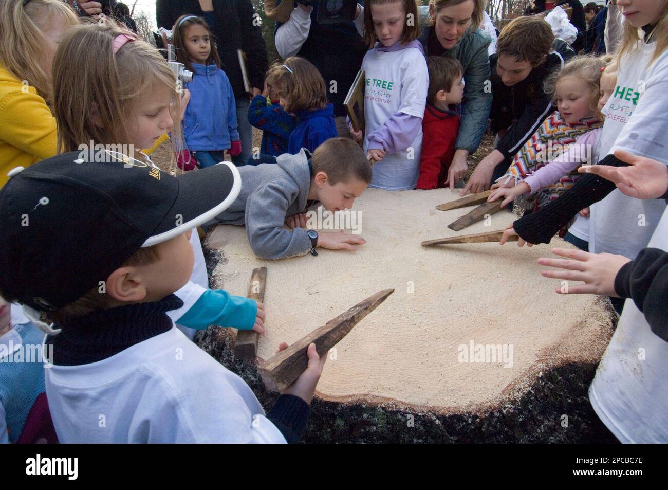 Children mill around the stump of the 2006 Rockefeller Center Christmas ...