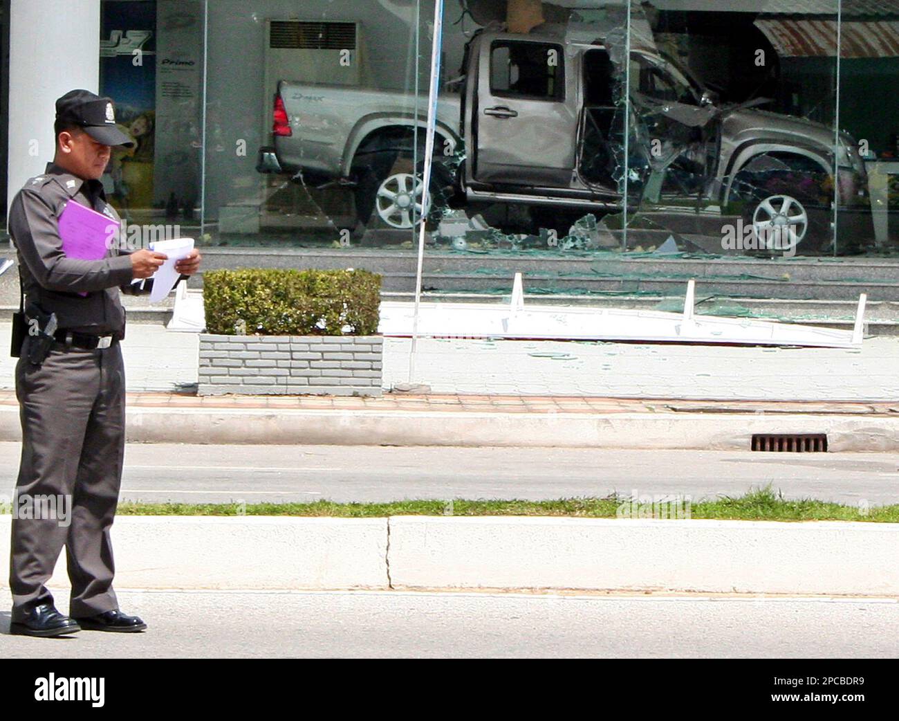 A Thai bomb squad officer man at a damaged car showroom in Yala ...