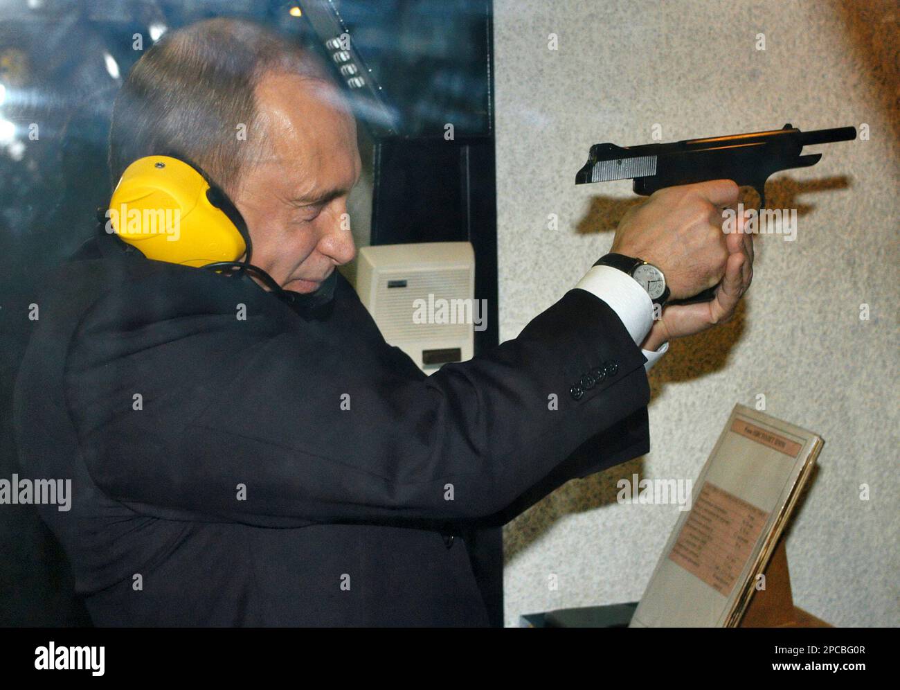 President Vladimir Putin tests a pistol at a shooting range in the ...