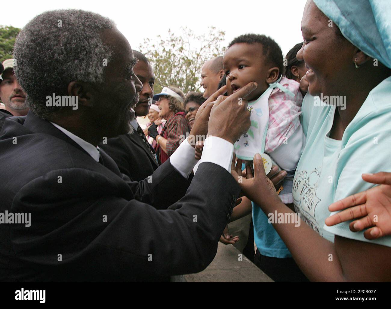 South African president Thabo Mbeki, left, greets Thabile Ngubeni, 5 ...