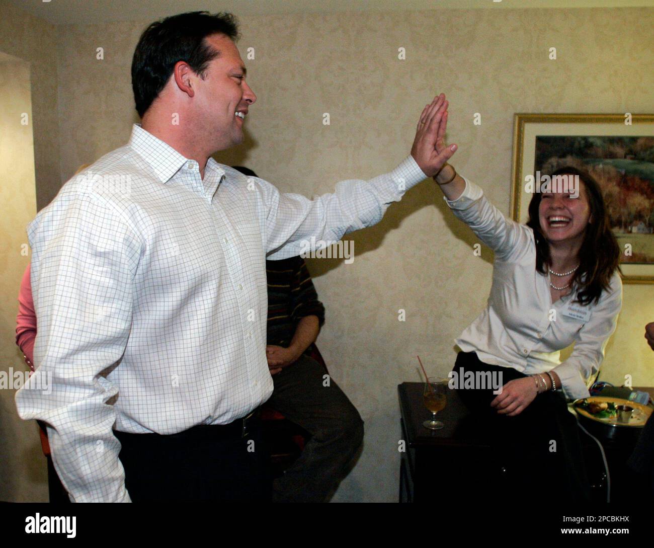 Democrat Heath Shuler, left, gets a high five from Alexis Stoller ...