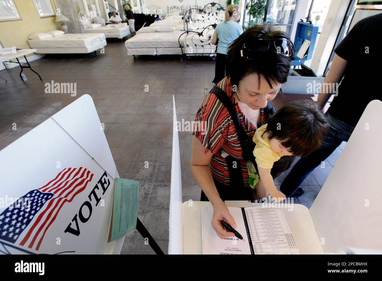 Jenifer Roper with her daughter Romy Bendl, casts her vote at a Sleep ...