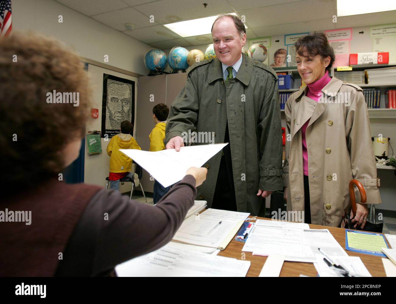 Poll judge Mary Dore-Cockerham, left, hands a ballot to U.S. Senate ...