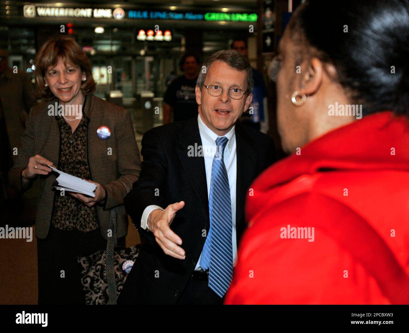 Sen. Mike DeWine, R-Ohio, right, greets commuters at the rapid transit ...
