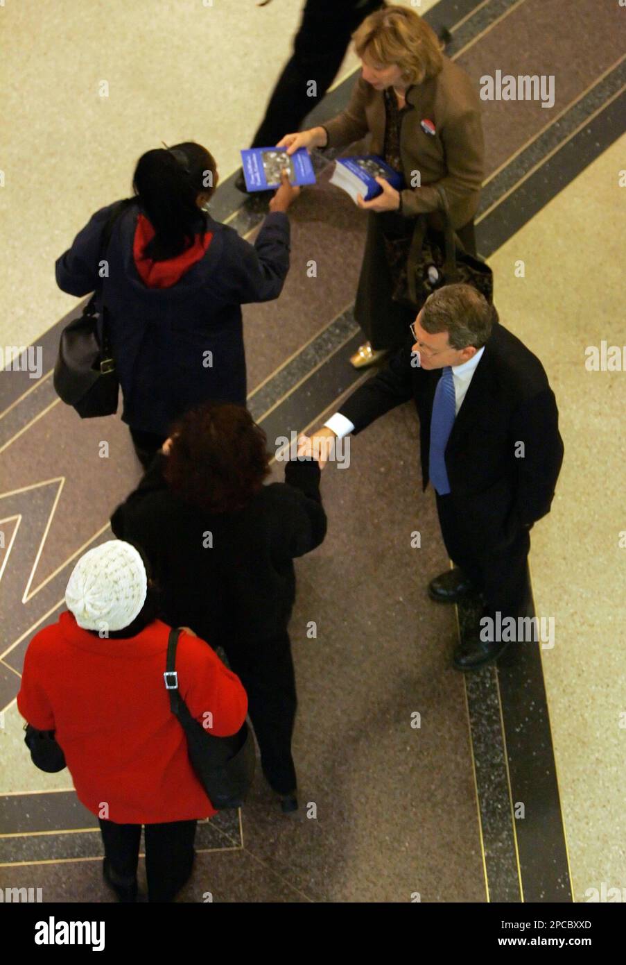 Sen. Mike DeWine, R-Ohio, right, greets commuters at the rapid transit ...