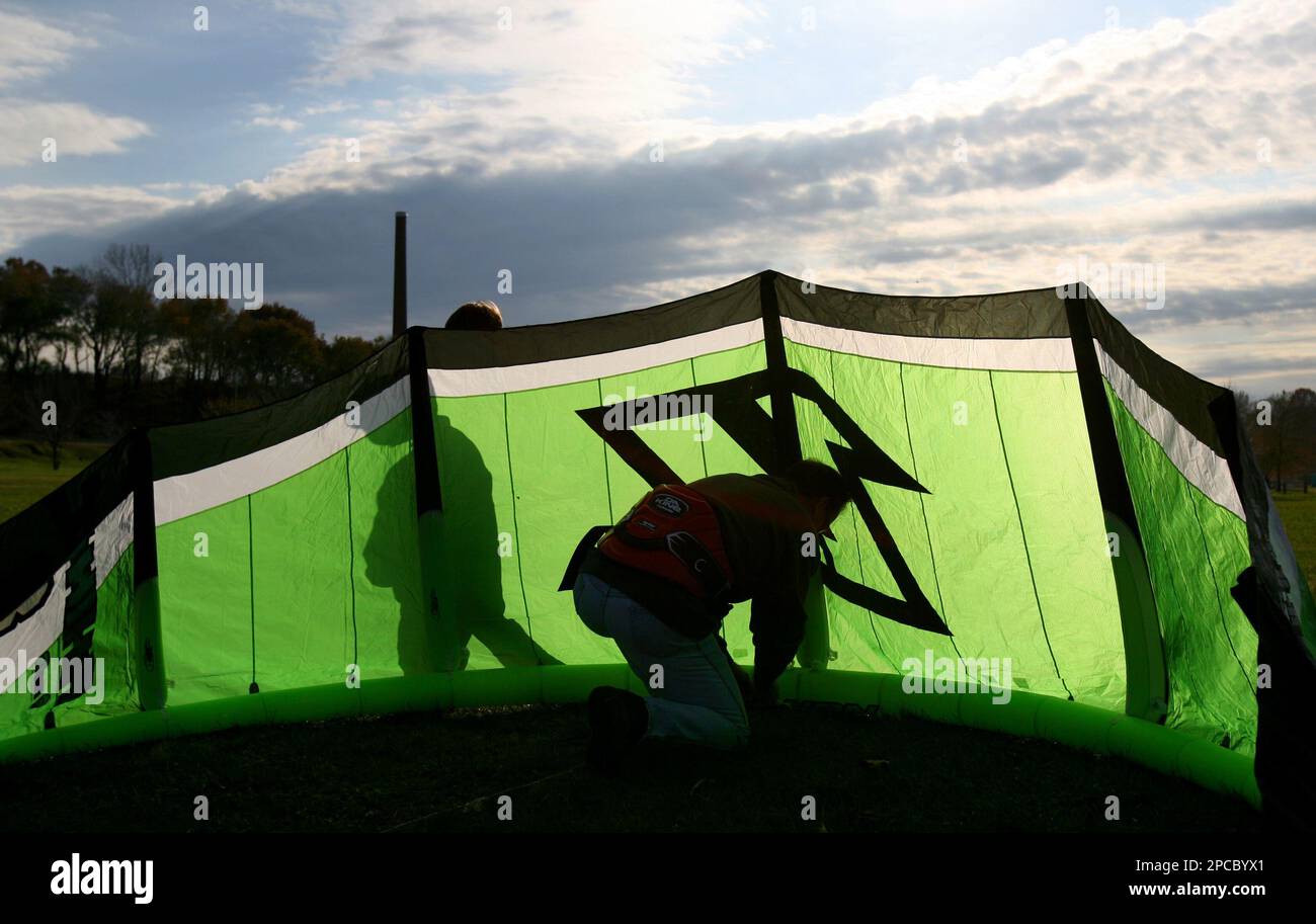 Chris Erhardt, right, positions his kite with the help of his son, Nick ...