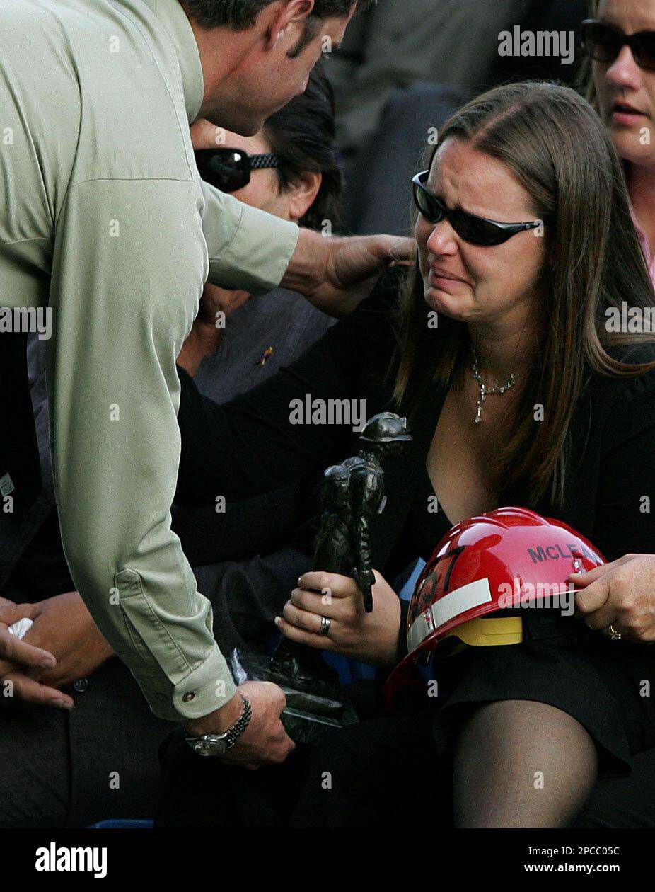 A family member of U.S. Forest Service firefighter Jess McLean cries as ...