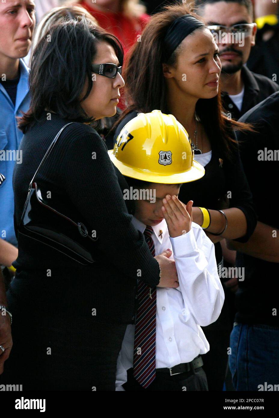 Gloria Ayala holds her son, Mike, who is wearing his step-brother's ...